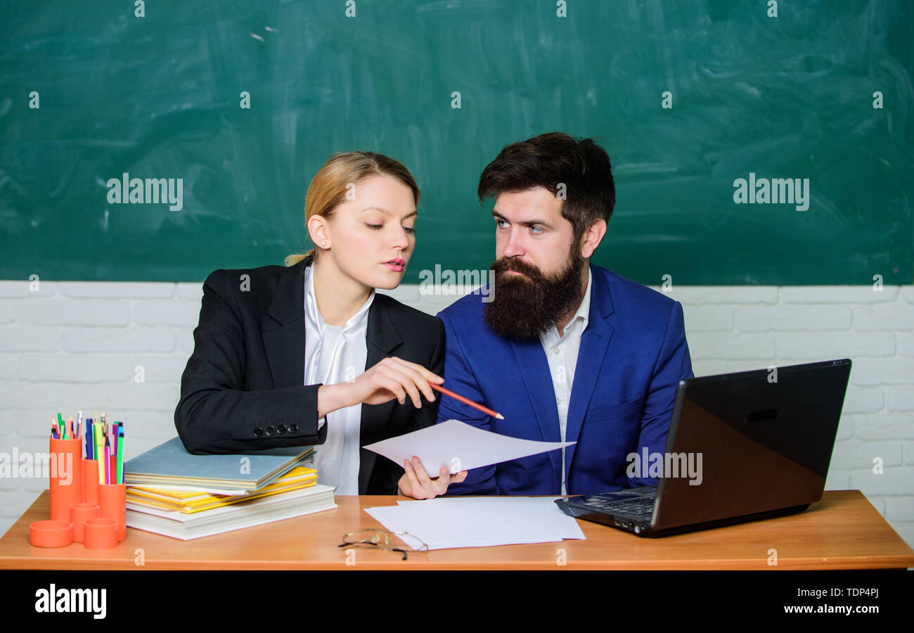 Teacher and supervisor working in school classroom. School educator ...