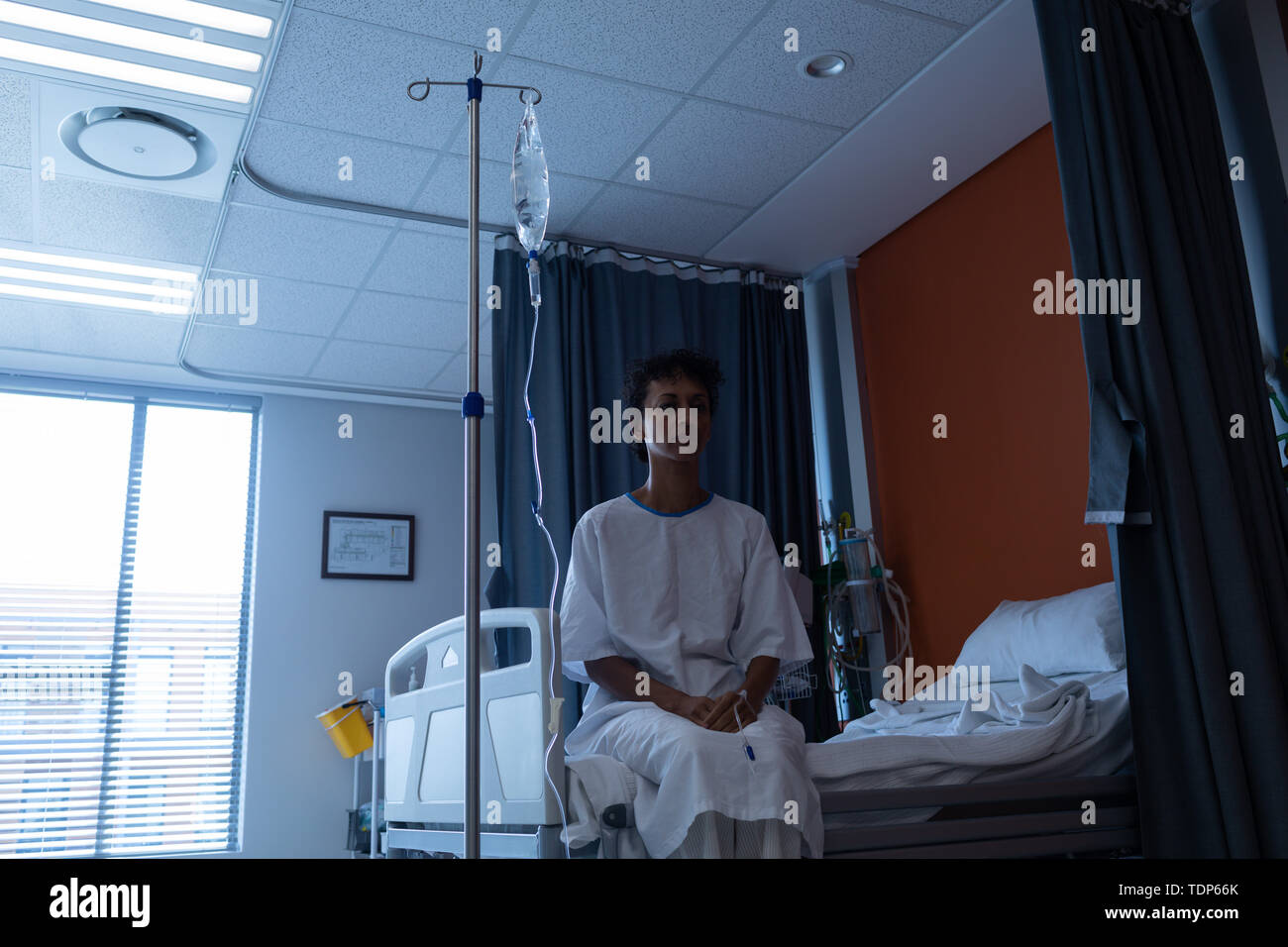 Female patient relaxing on bed in hospital Stock Photo - Alamy