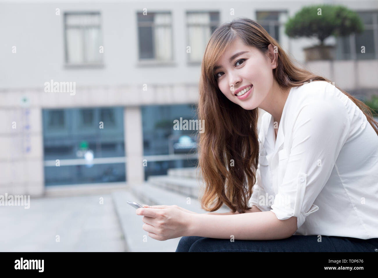 Asian beautiful female student using mobile phone in campus Stock Photo ...