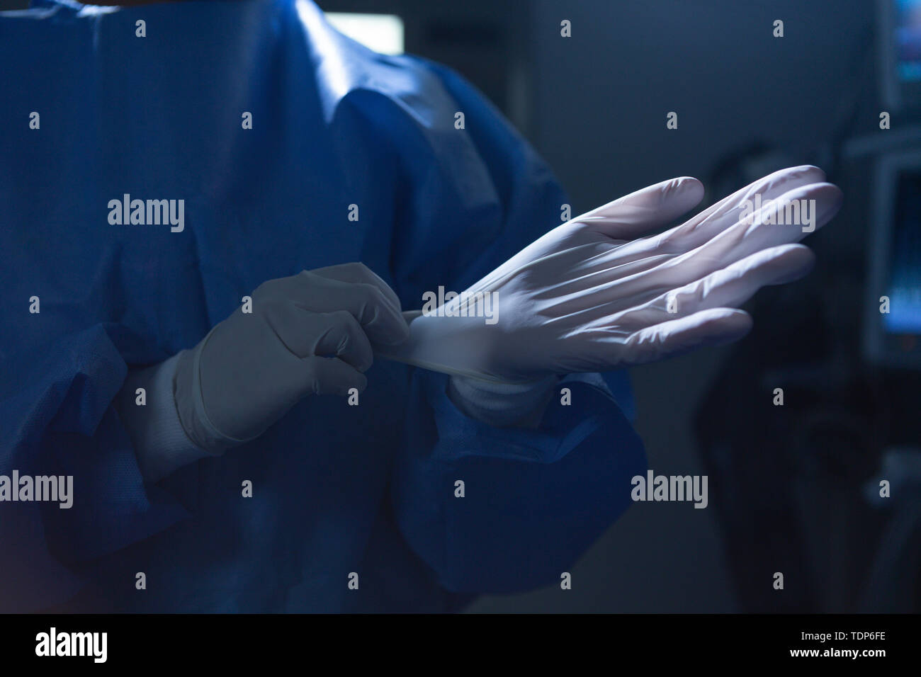 Female surgeon with surgical gloves in operation room Stock Photo - Alamy
