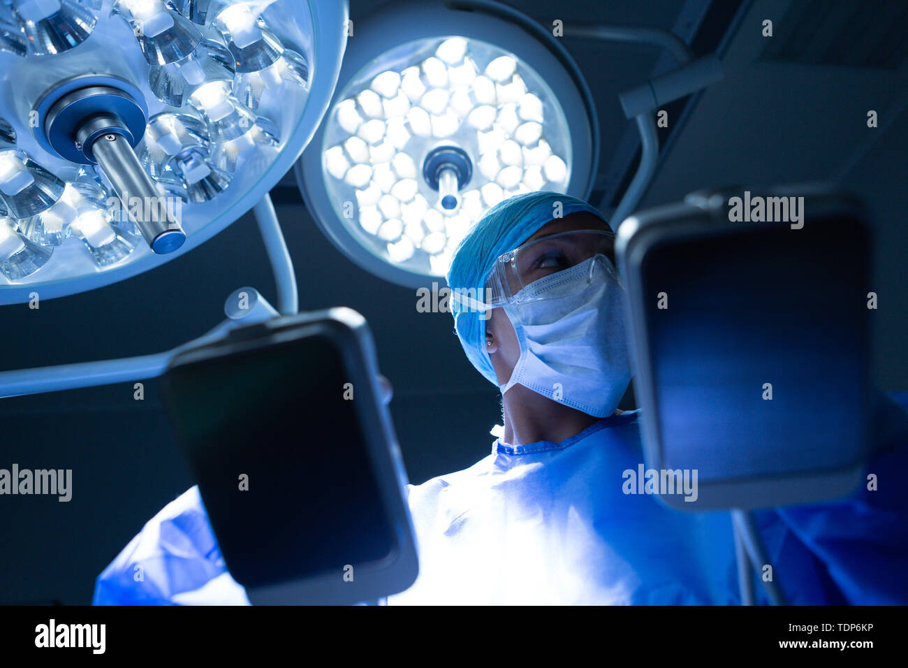 Female surgeon holding defibrillator in operation theater Stock Photo ...