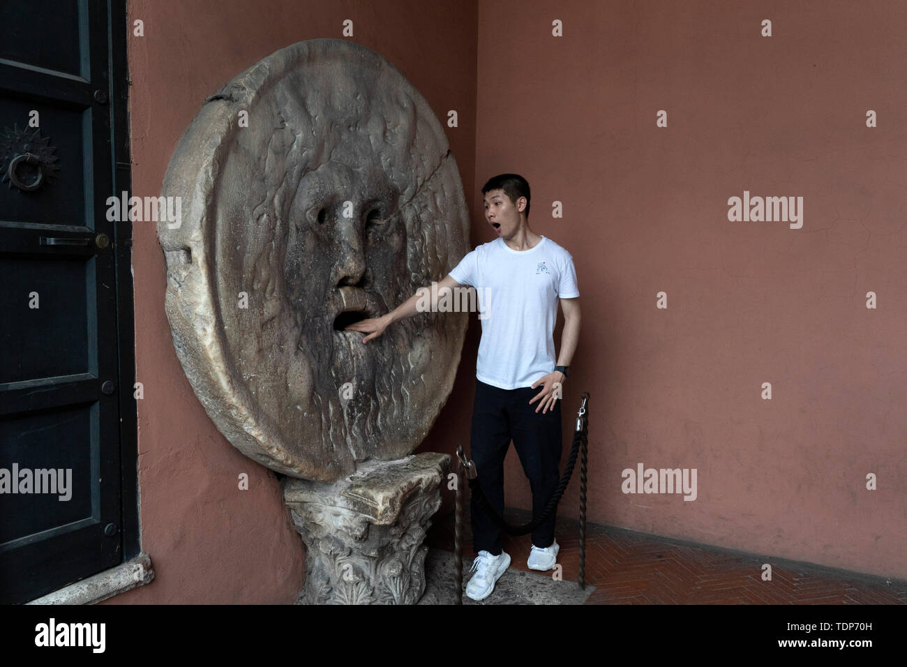 ROME, ITALY - JUNE 15 2019 - Tourist testing the mouth of truth mask ...