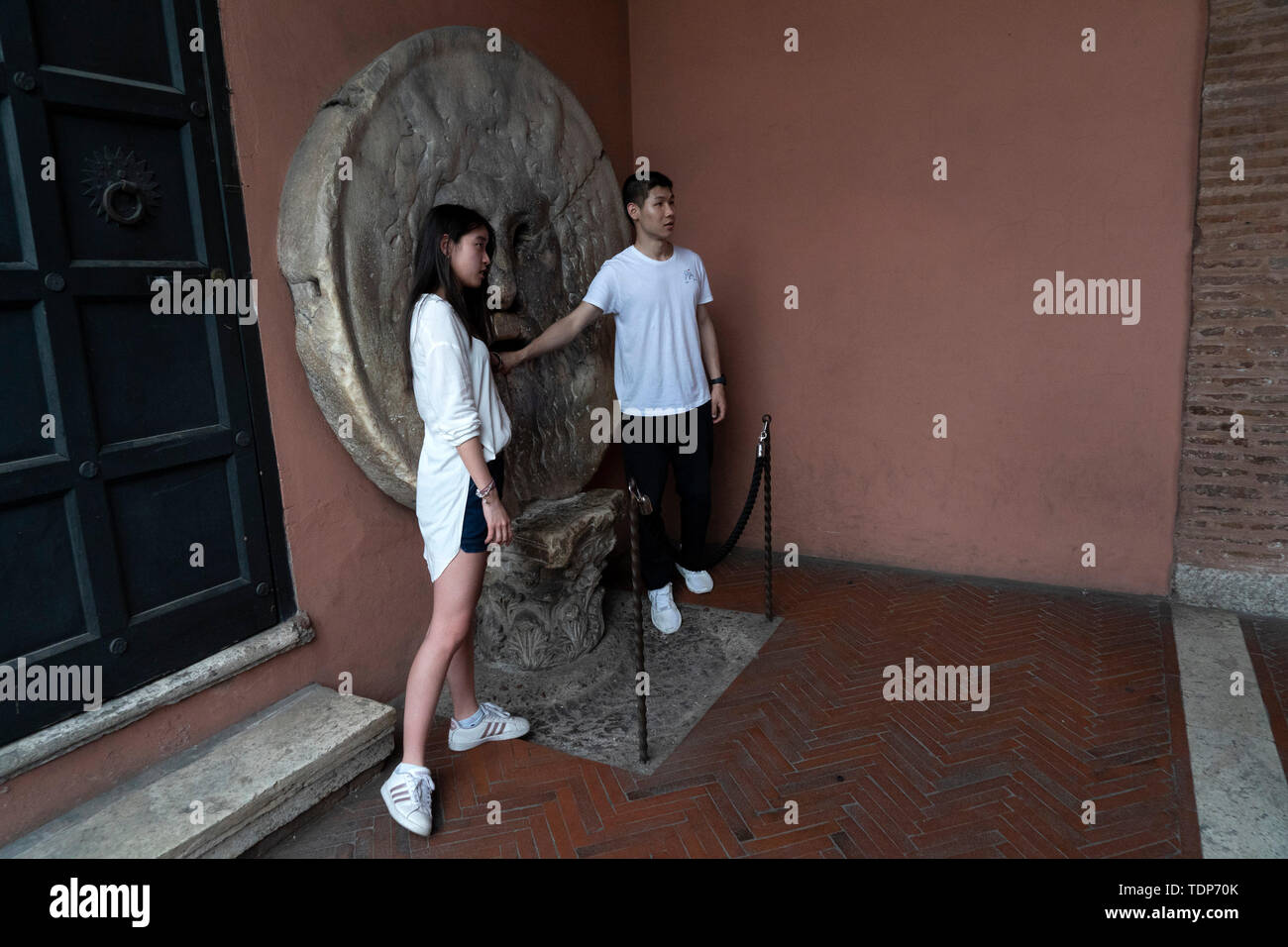ROME, ITALY - JUNE 15 2019 - Tourist testing the mouth of truth mask ...