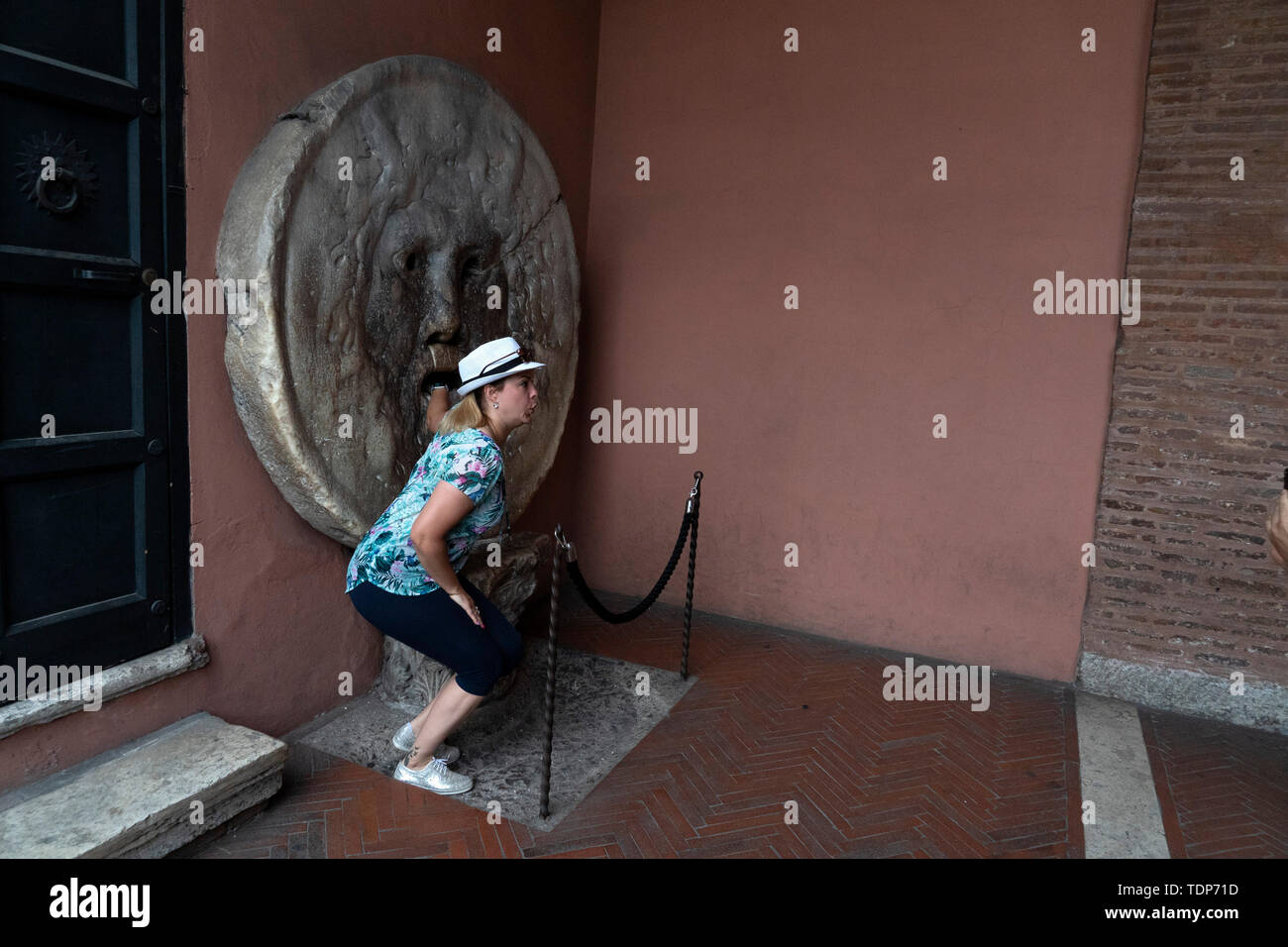 ROME, ITALY - JUNE 15 2019 - Tourist testing the mouth of truth mask ...