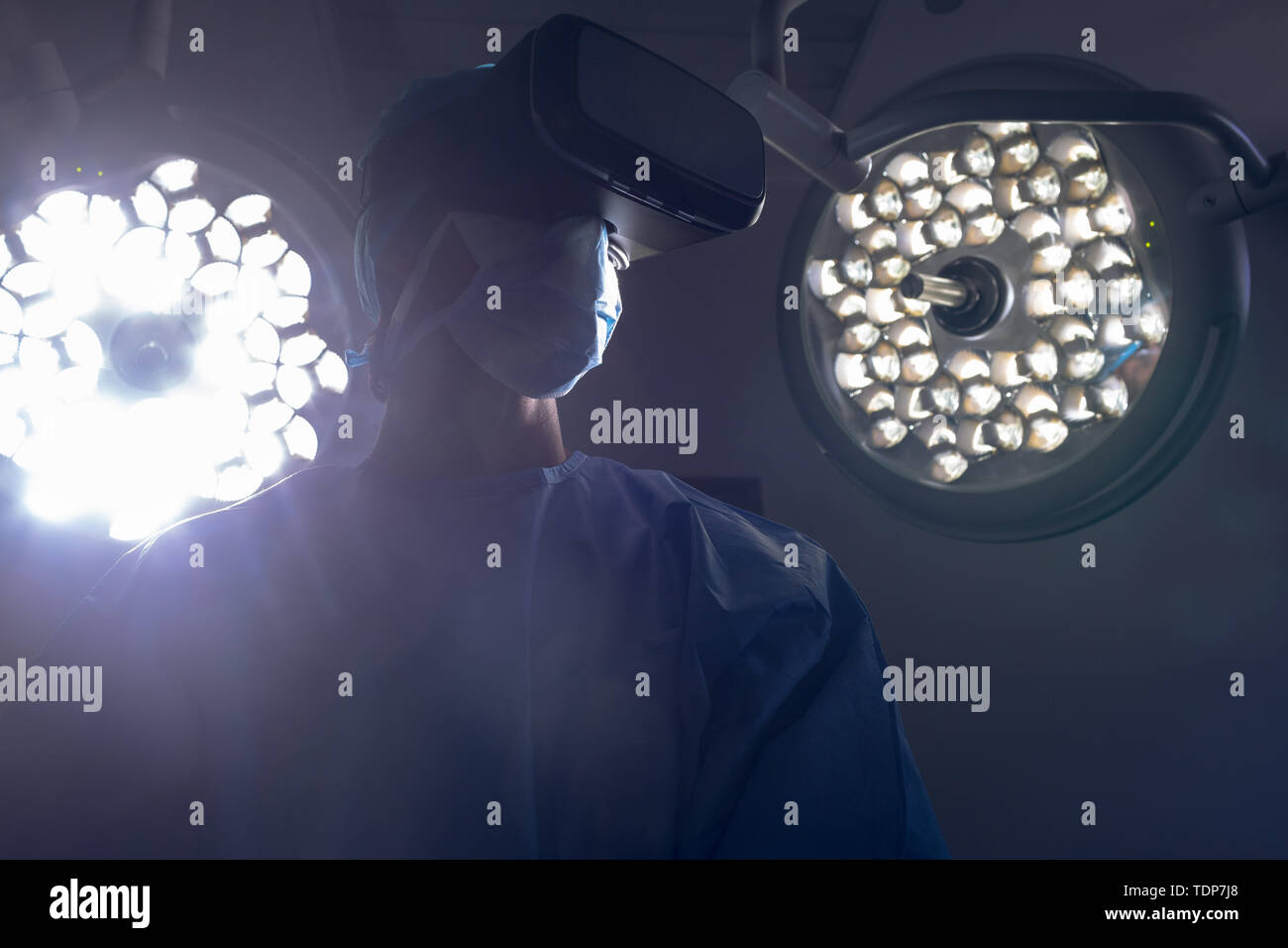 Male surgeon using virtual reality headset in operating room at ...