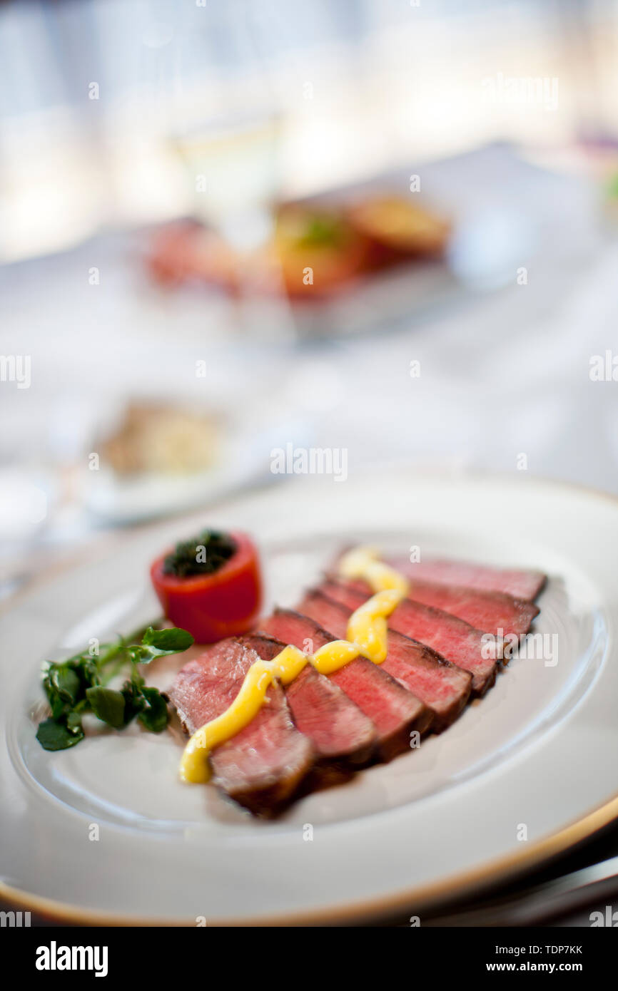Sliced beef served with sauce Stock Photo - Alamy