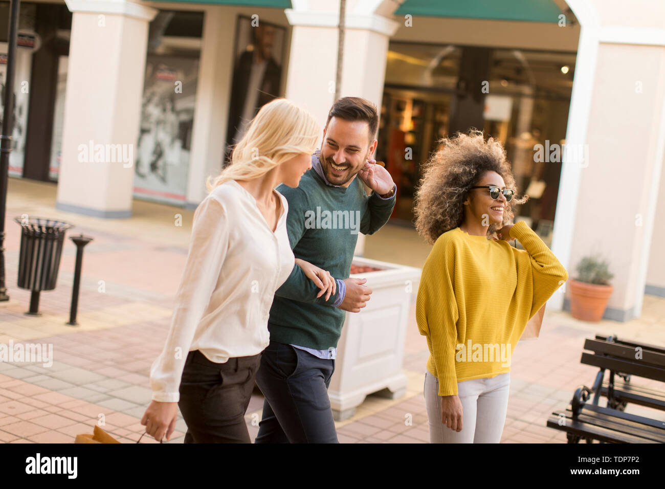 Three friends walking shopping bags hi-res stock photography and images ...