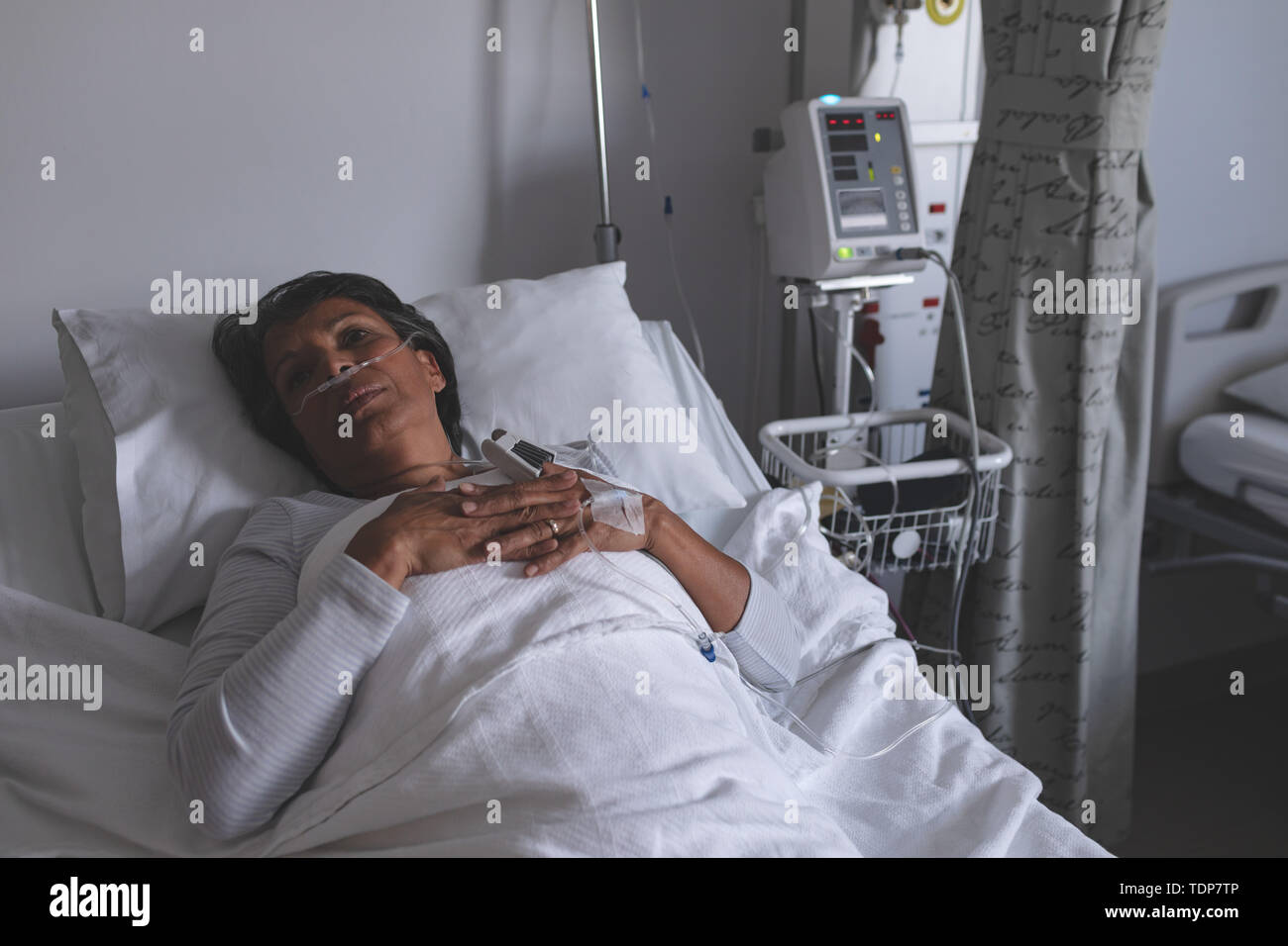 Female patient relaxing in bed in the ward at hospital Stock Photo - Alamy