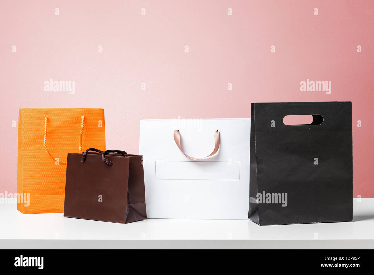 few different shopping bags on the desk Stock Photo - Alamy
