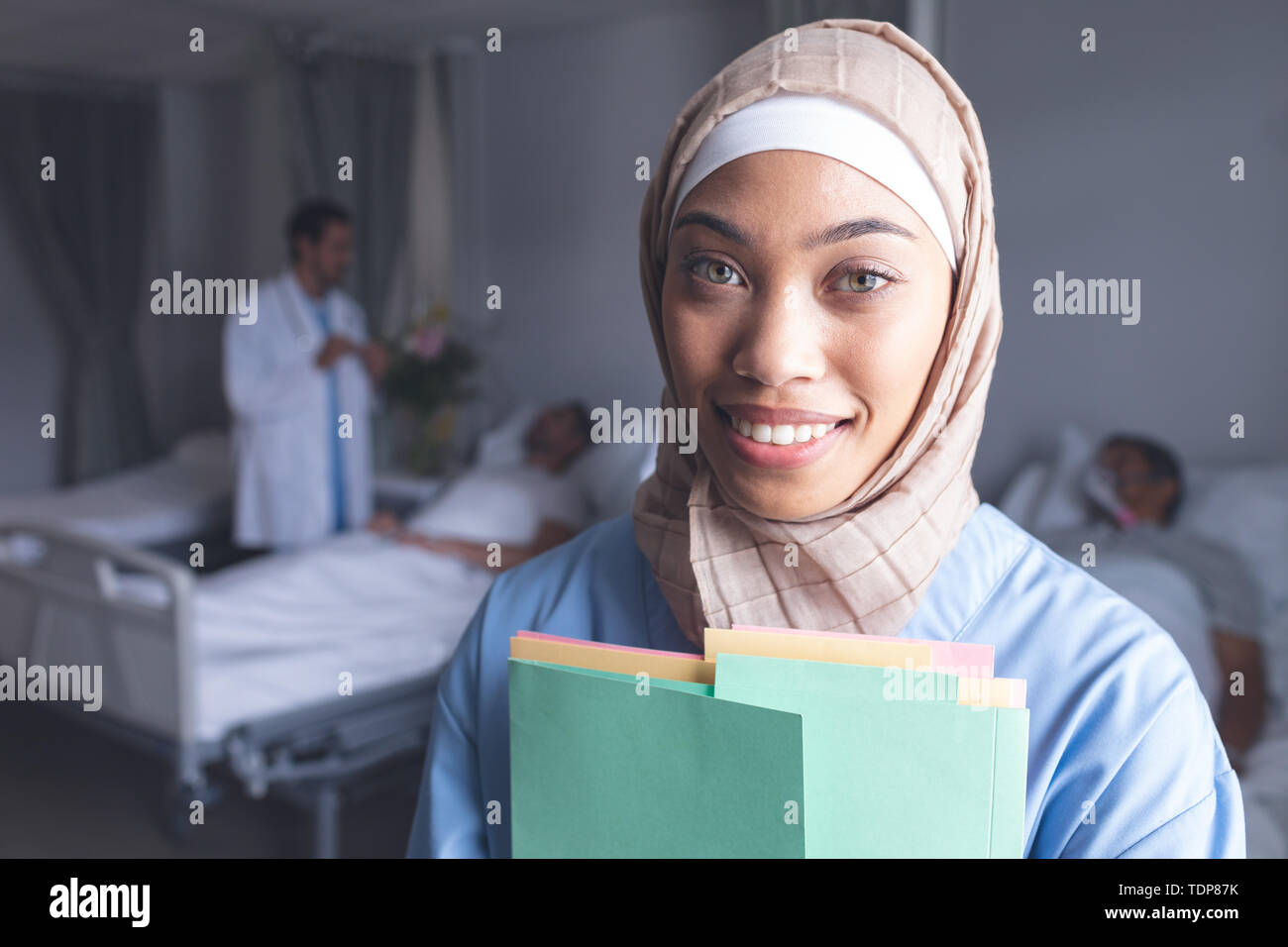 Female doctor standing with medical files in the ward at hospital Stock ...