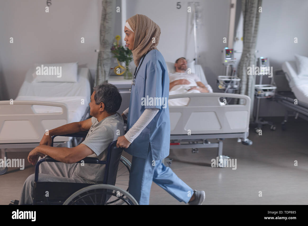 Doctor pushing patient in wheelchair hi-res stock photography and ...