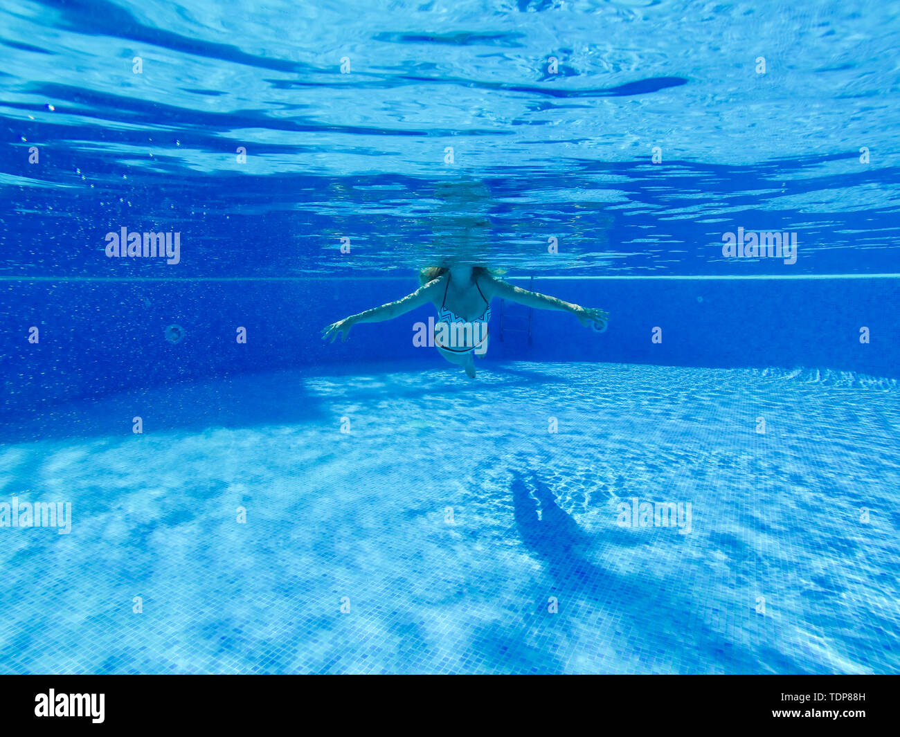 Young lady swimming underwater in the pool Stock Photo - Alamy
