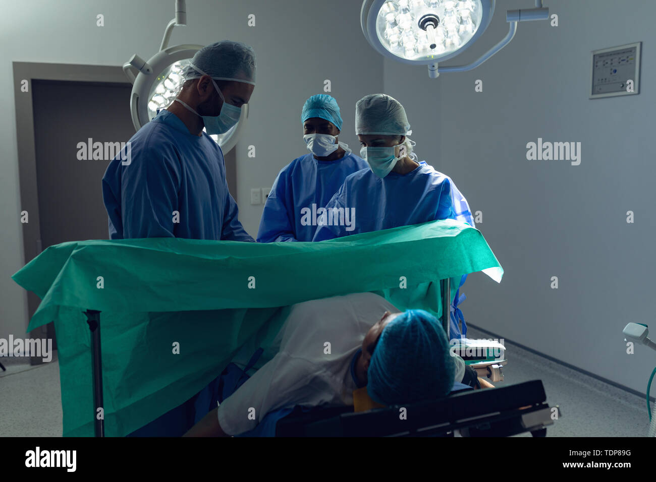 Medical team examining pregnant woman during delivery in operation ...