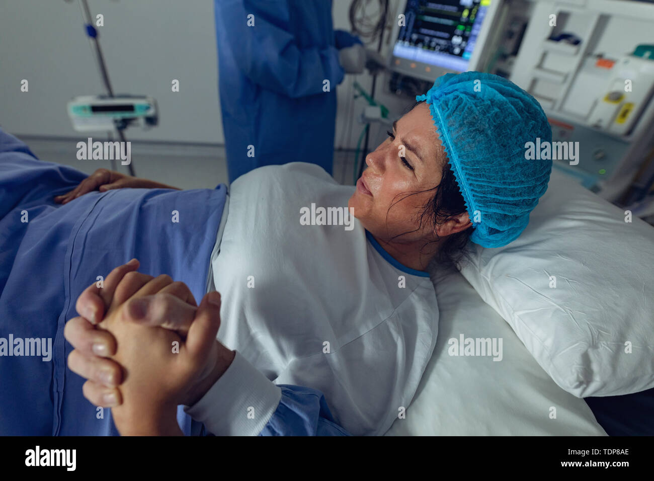 Man comforting pregnant woman during labor in operation theater Stock ...
