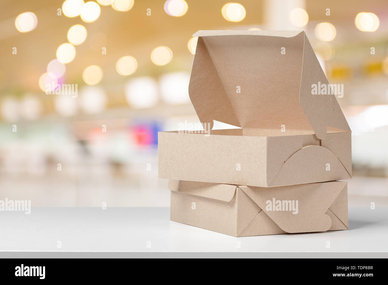 cardboard box on white desk Stock Photo - Alamy