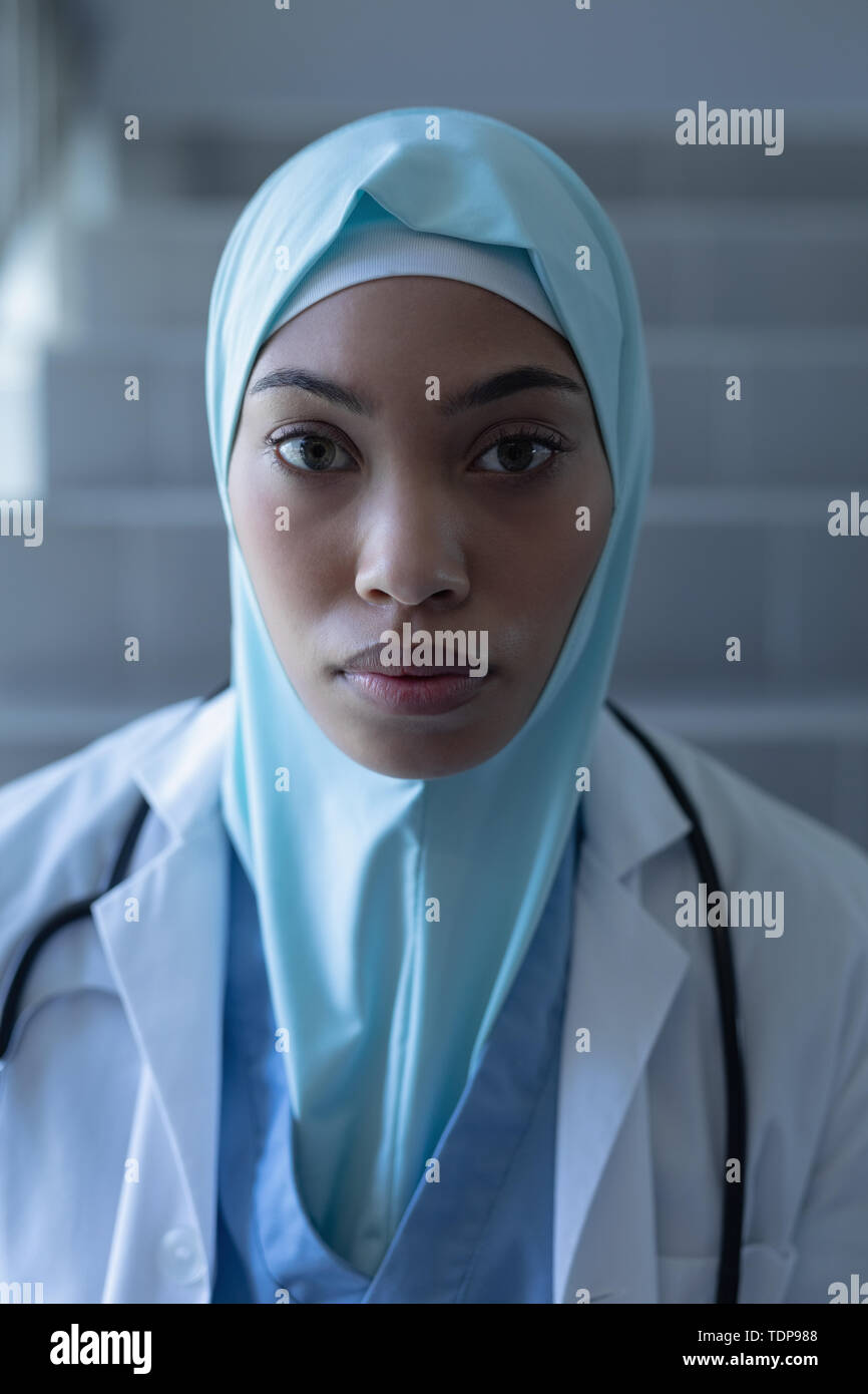 Female doctor in hijab sitting on staircase in the hospital Stock Photo ...