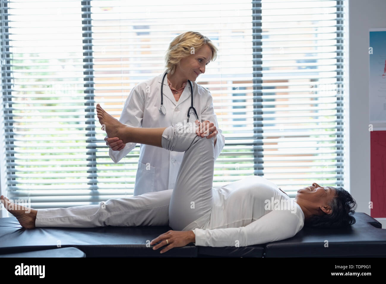 Female doctor examining her patient leg in hospital Stock Photo - Alamy