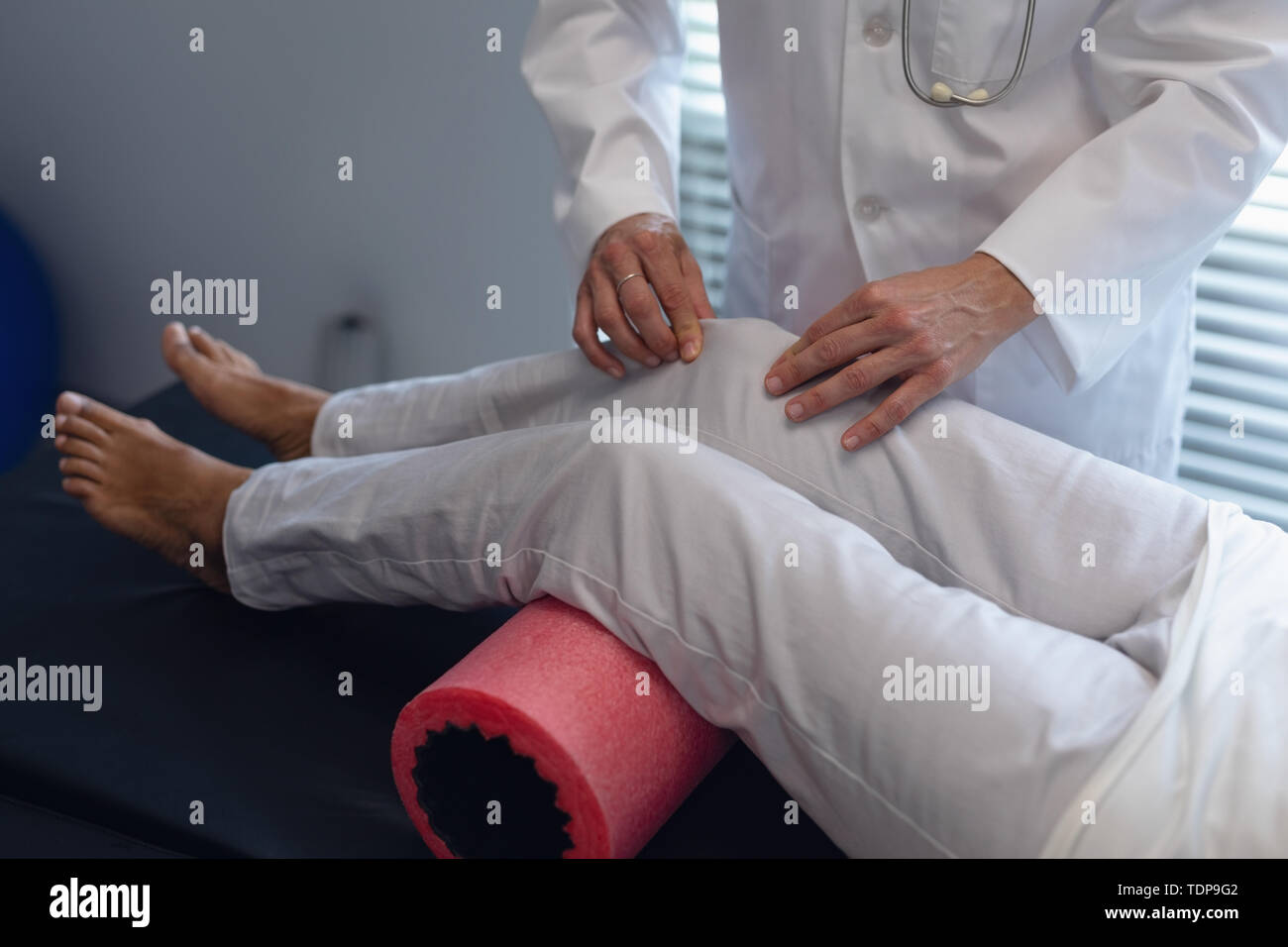 Female doctor using foam roller on patient leg in hospital Stock Photo ...