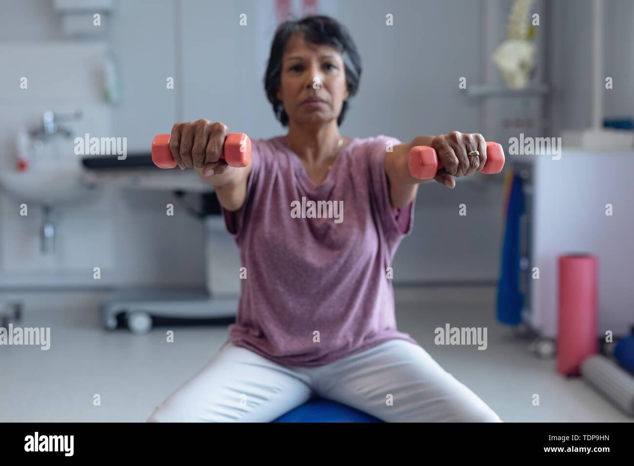 Female patient exercising with dumbbells in the hospital Stock Photo ...