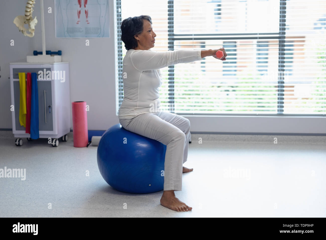 Female patient exercising with dumbbells in the hospital Stock Photo ...