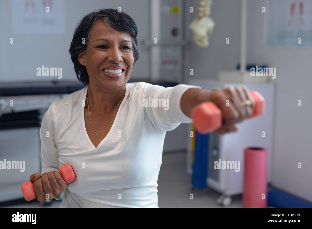 Female patient exercising with dumbbells in the hospital Stock Photo ...