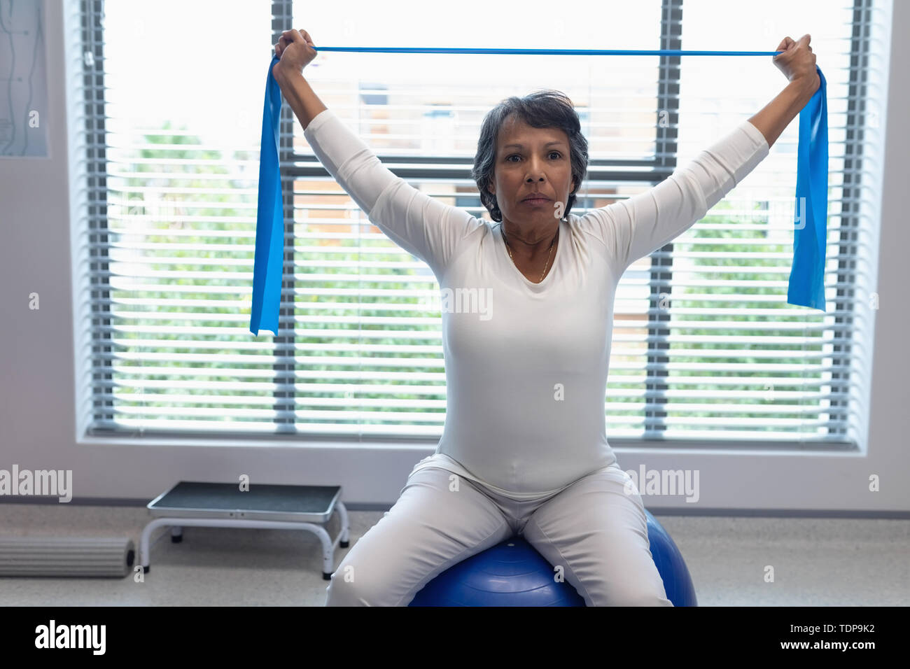 Female patient exercising with resistance band in the hospital Stock ...