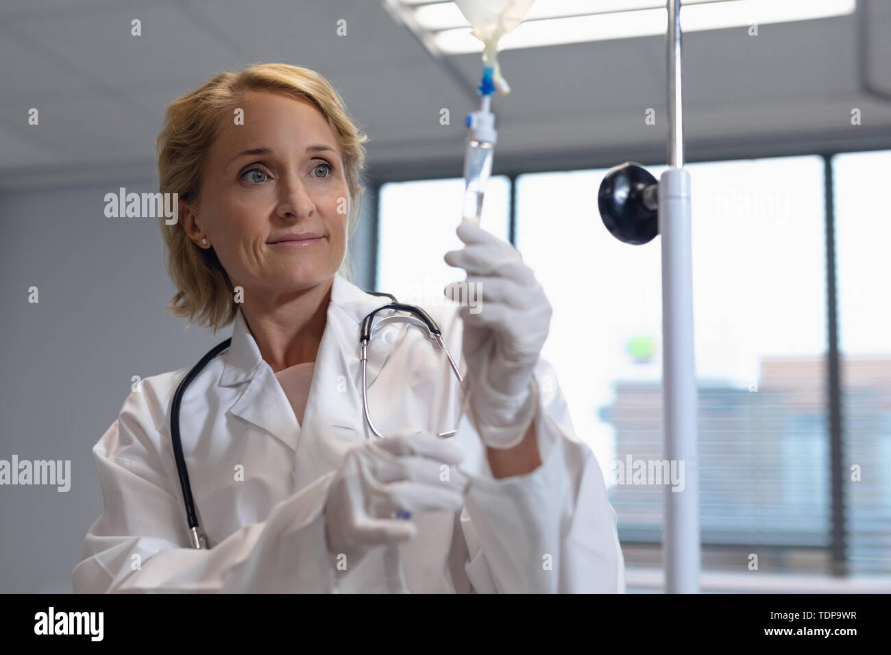 Female doctor adjusting iv drip in hospital Stock Photo - Alamy