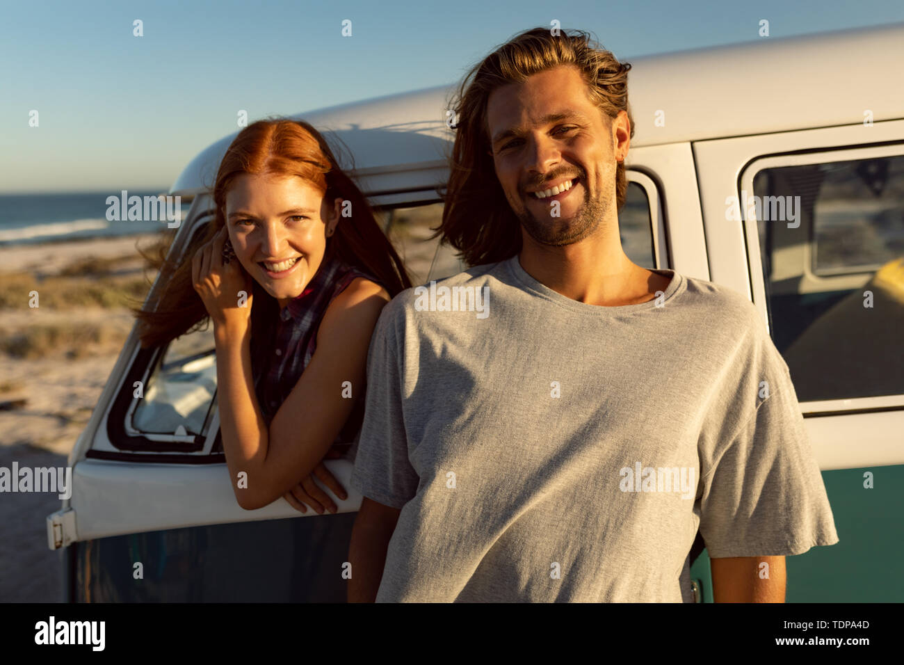 Woman leaning out of window while man standing beside her Stock Photo ...