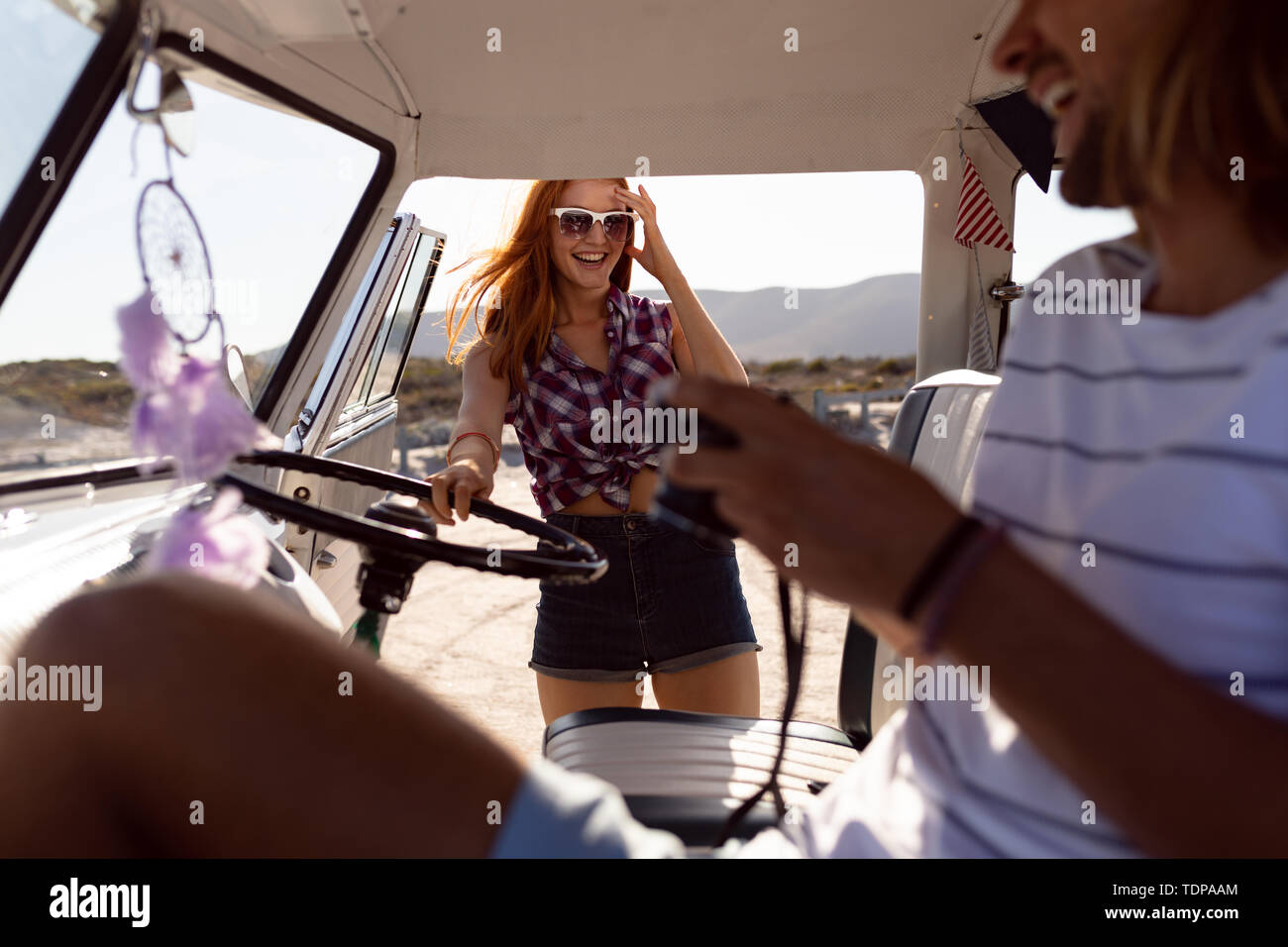 Happy couple having fun in camper van at beach Stock Photo - Alamy