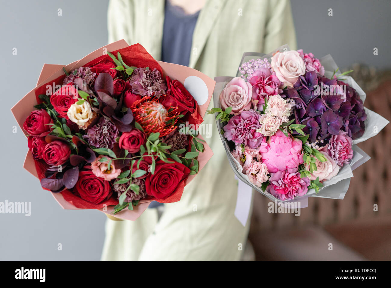 Two Small Beautiful bouquets of mixed flowers in woman hand. Floral ...