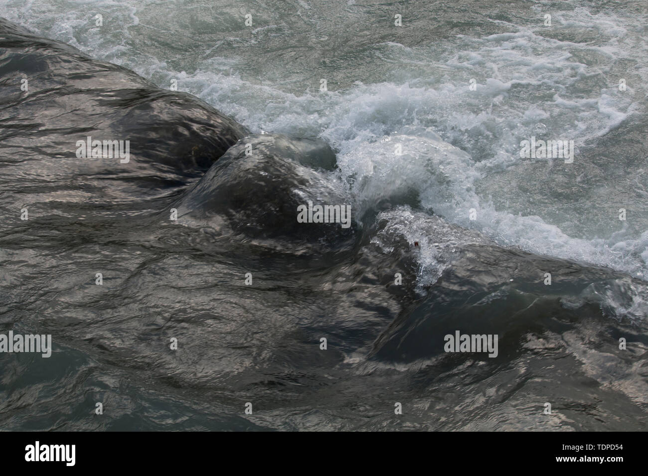 The stream of water flowing over rocks. Image close-up Stock Photo - Alamy
