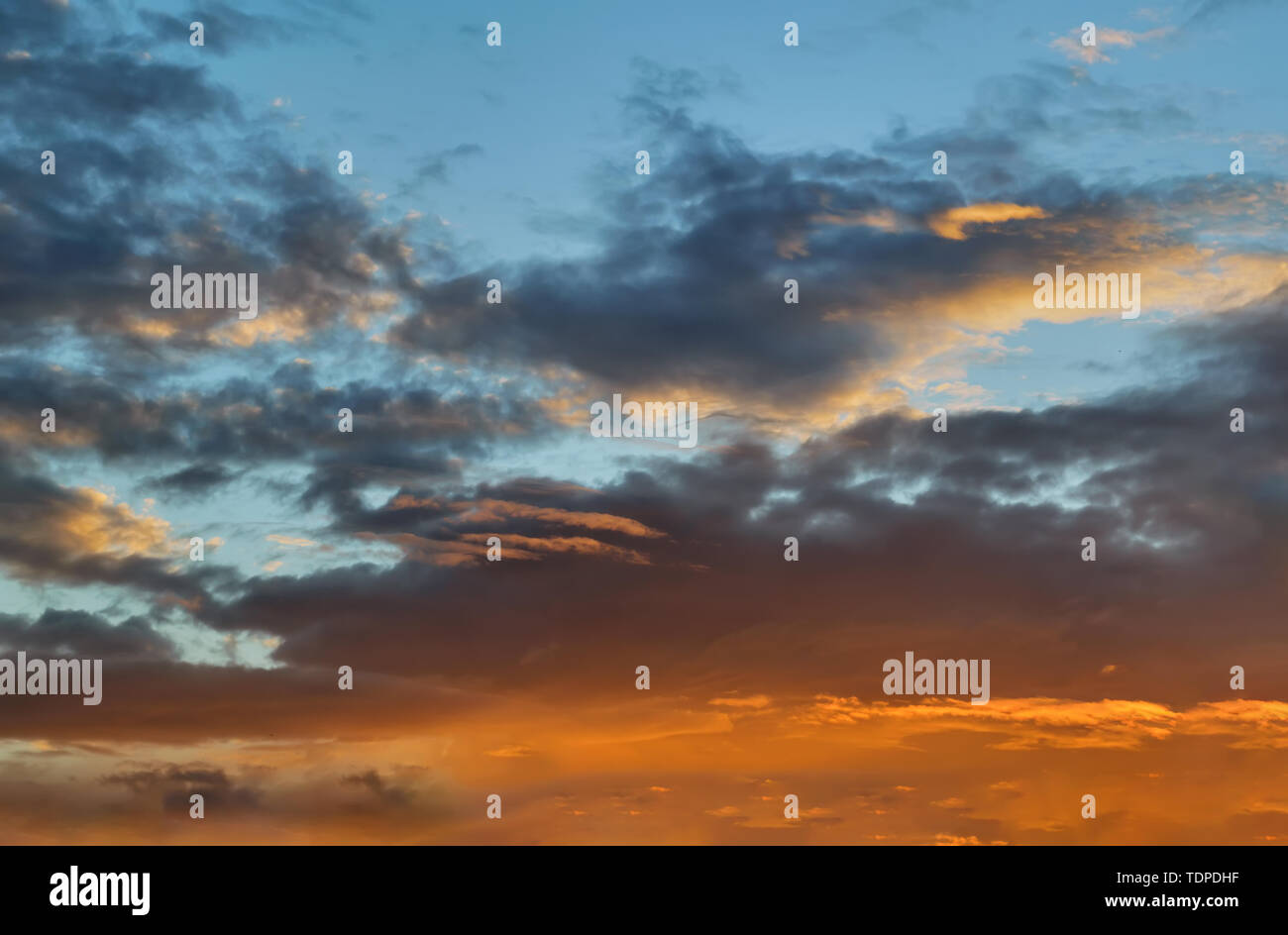 Cumulus sunset clouds with sun setting down. The sky with dark clouds ...