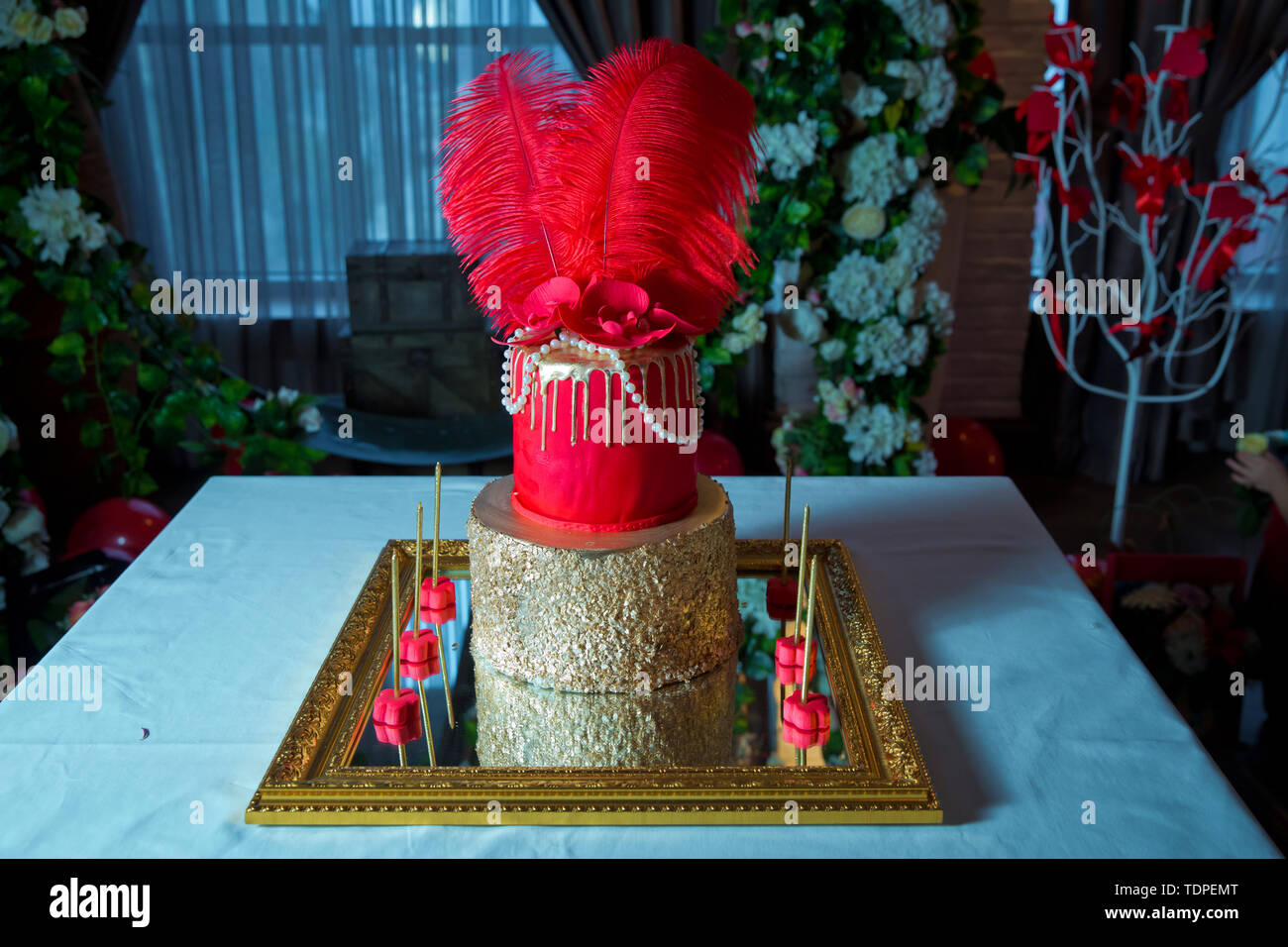 Cake with pearl beads on top. Red and golden cake. Feather cake Stock ...