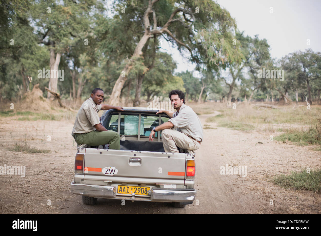 Men Riding In The Back Of A Van Stock Photo - Alamy