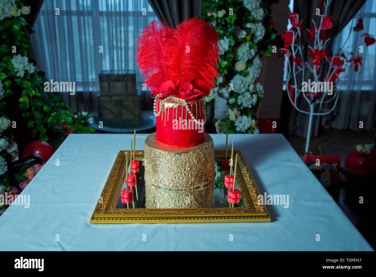 Cake with pearl beads on top. Red and golden cake. Feather cake Stock ...