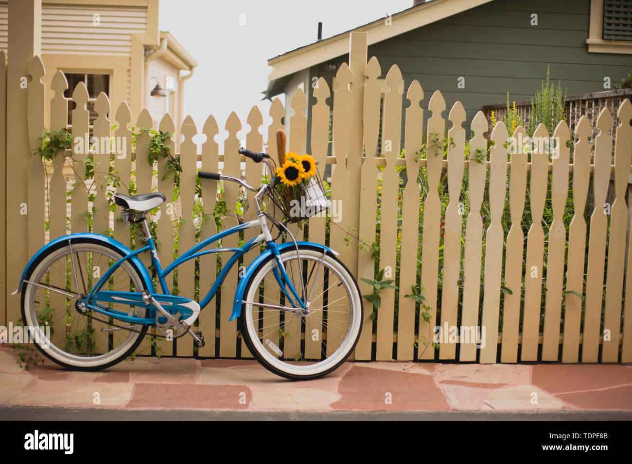 Bicycle leaning against a fence Stock Photo - Alamy