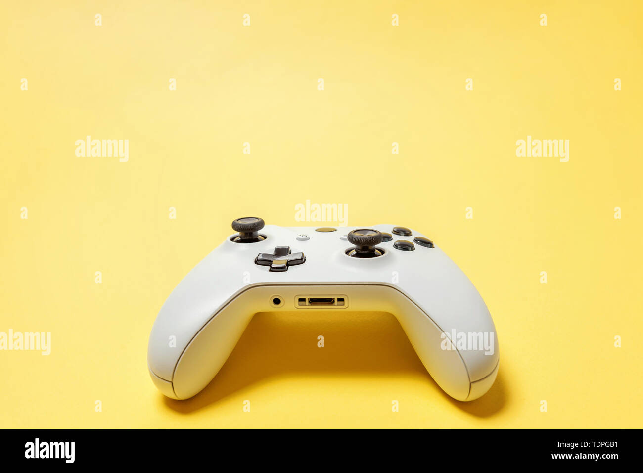 White joystick gamepad, game console on yellow colourful trendy modern ...