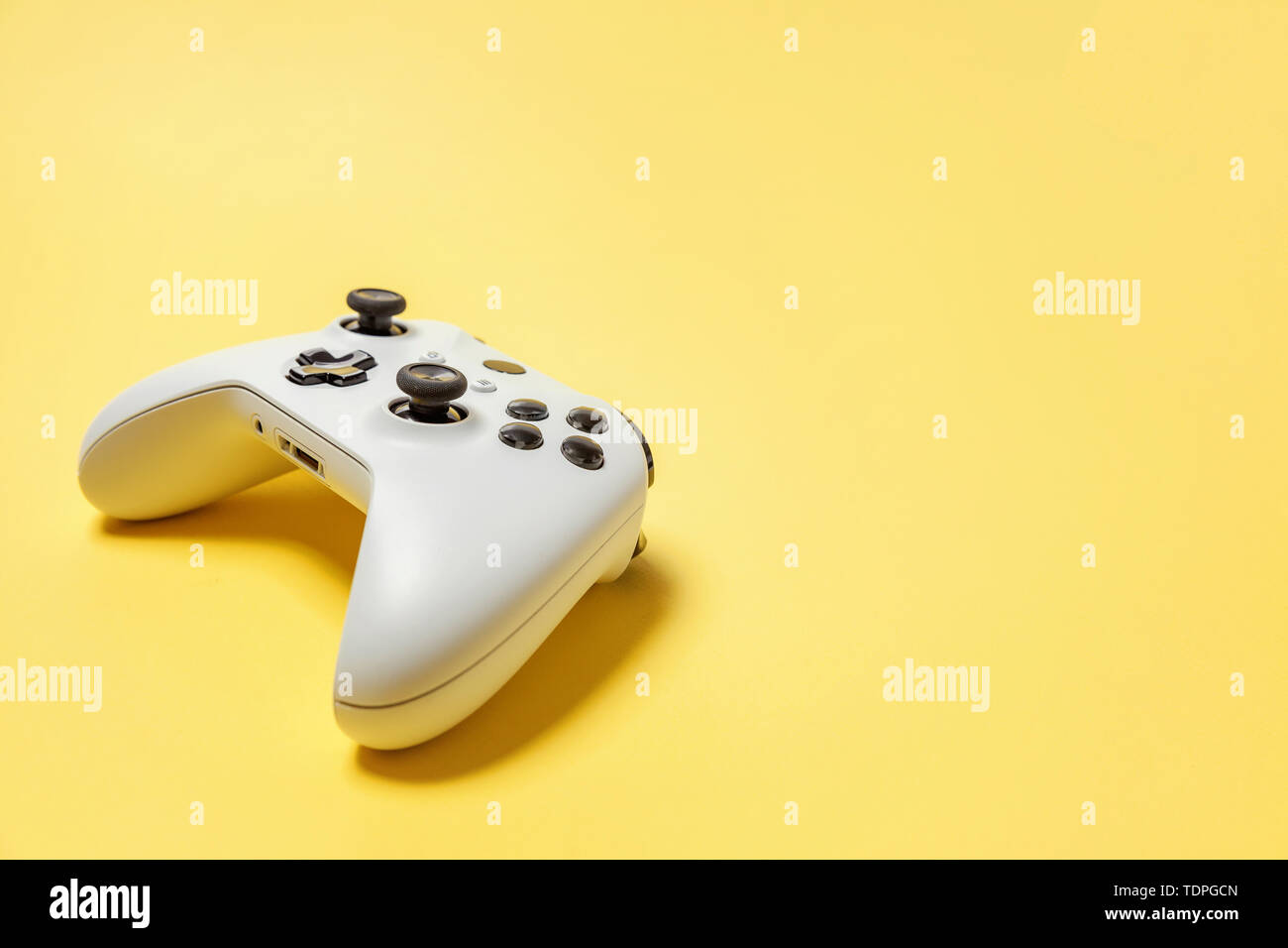 White joystick gamepad, game console on yellow colourful trendy modern ...