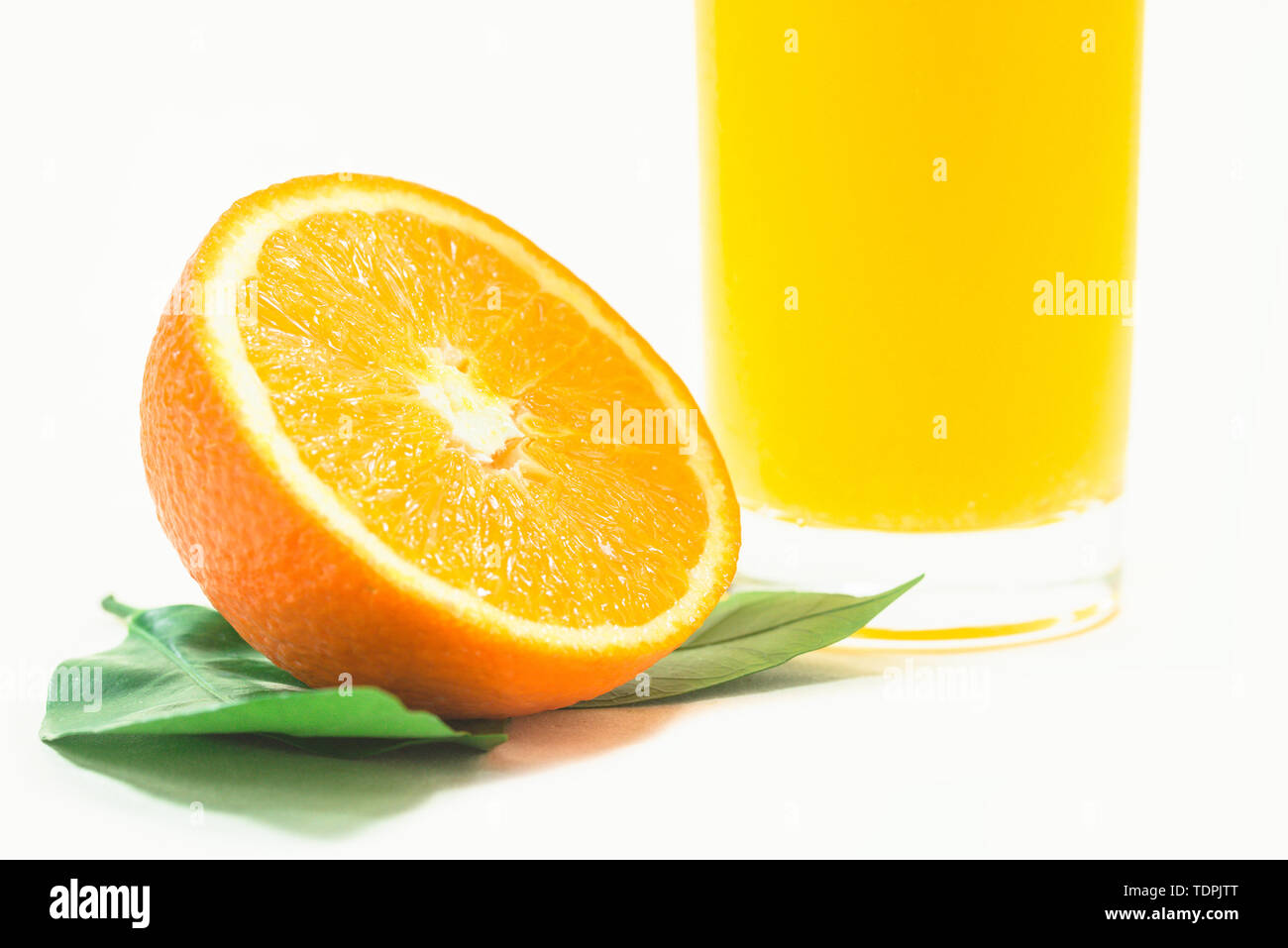 Cut orange with orange juice Stock Photo - Alamy