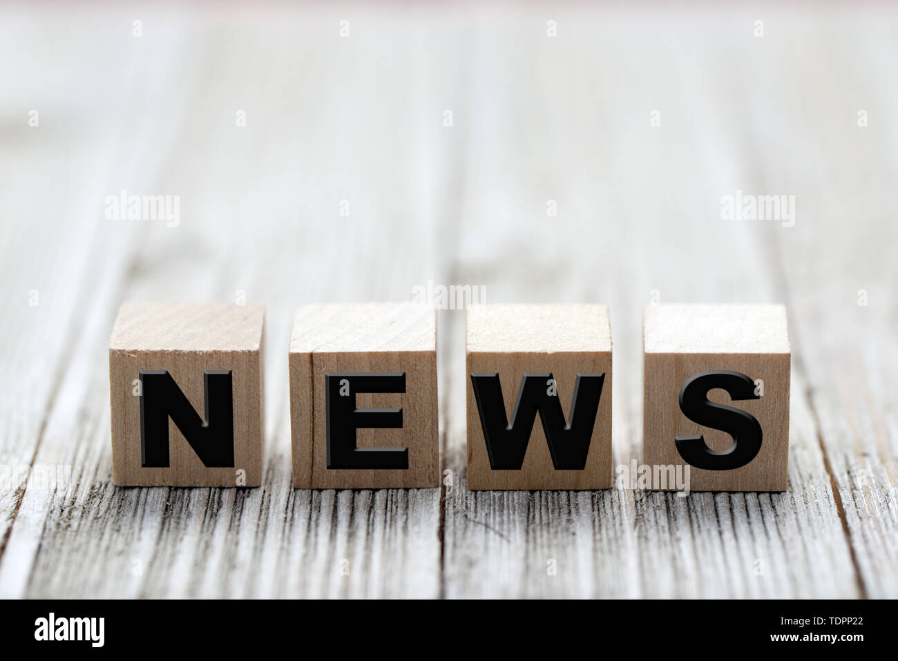 Wooden news sign on a wooden background Stock Photo - Alamy