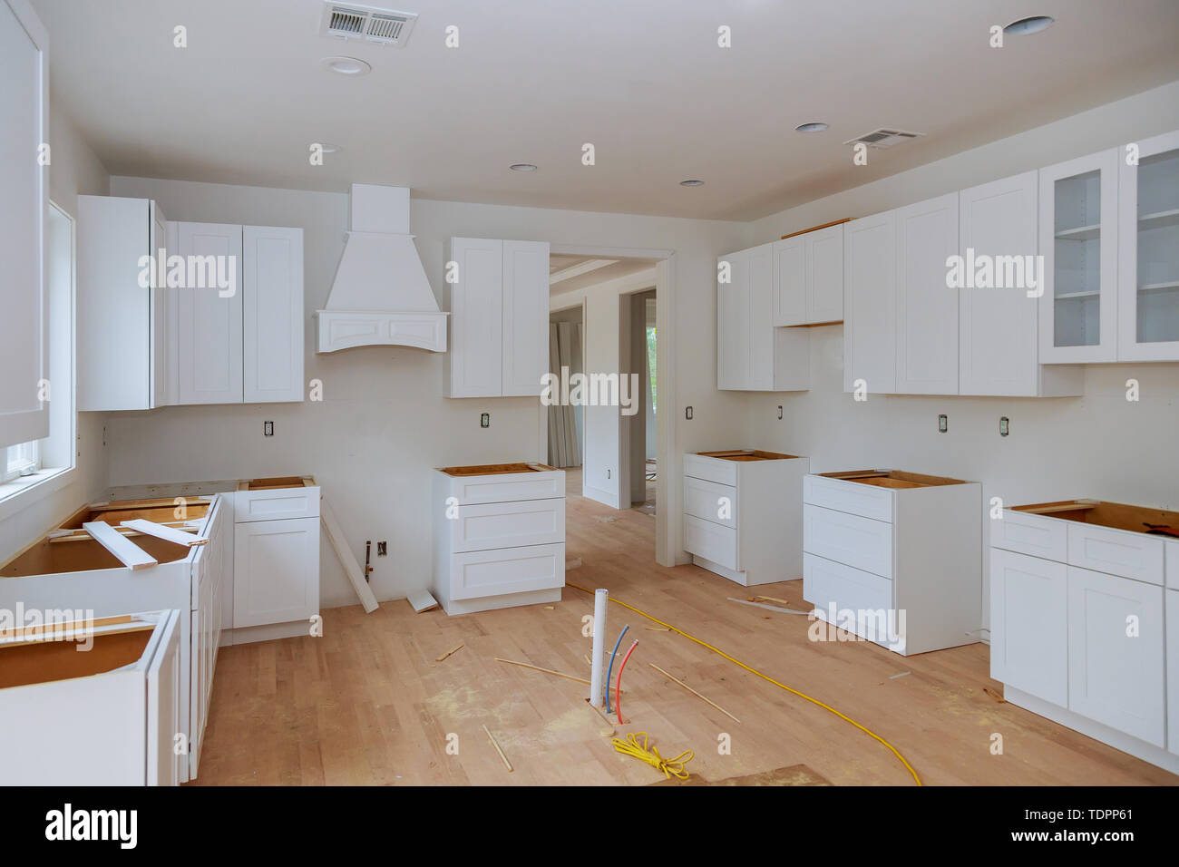 Preparing to install custom new kitchen cabinet in modern Stock Photo ...