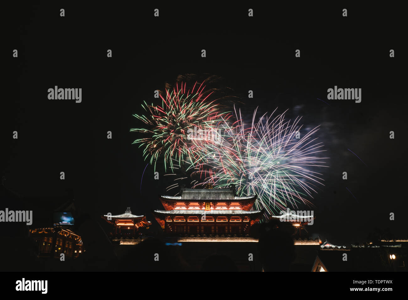 Fireworks blooming above Chinese ancient buildings Stock Photo - Alamy