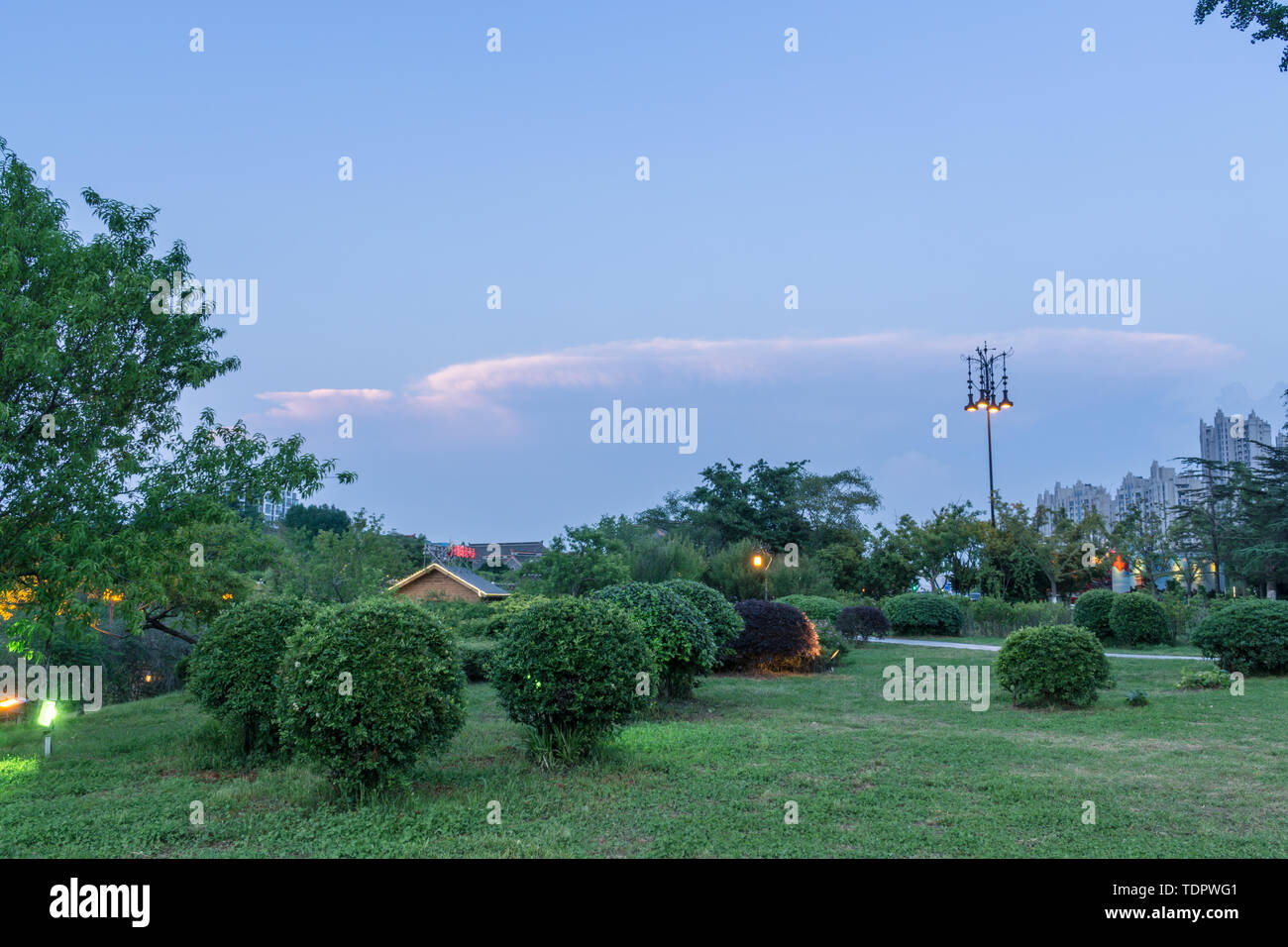 At dusk, park path, lawn, trees Stock Photo - Alamy