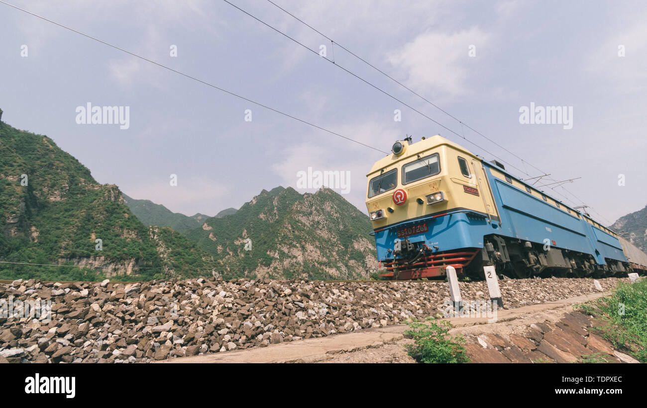 The freight train passes from the downhill bridge Stock Photo - Alamy