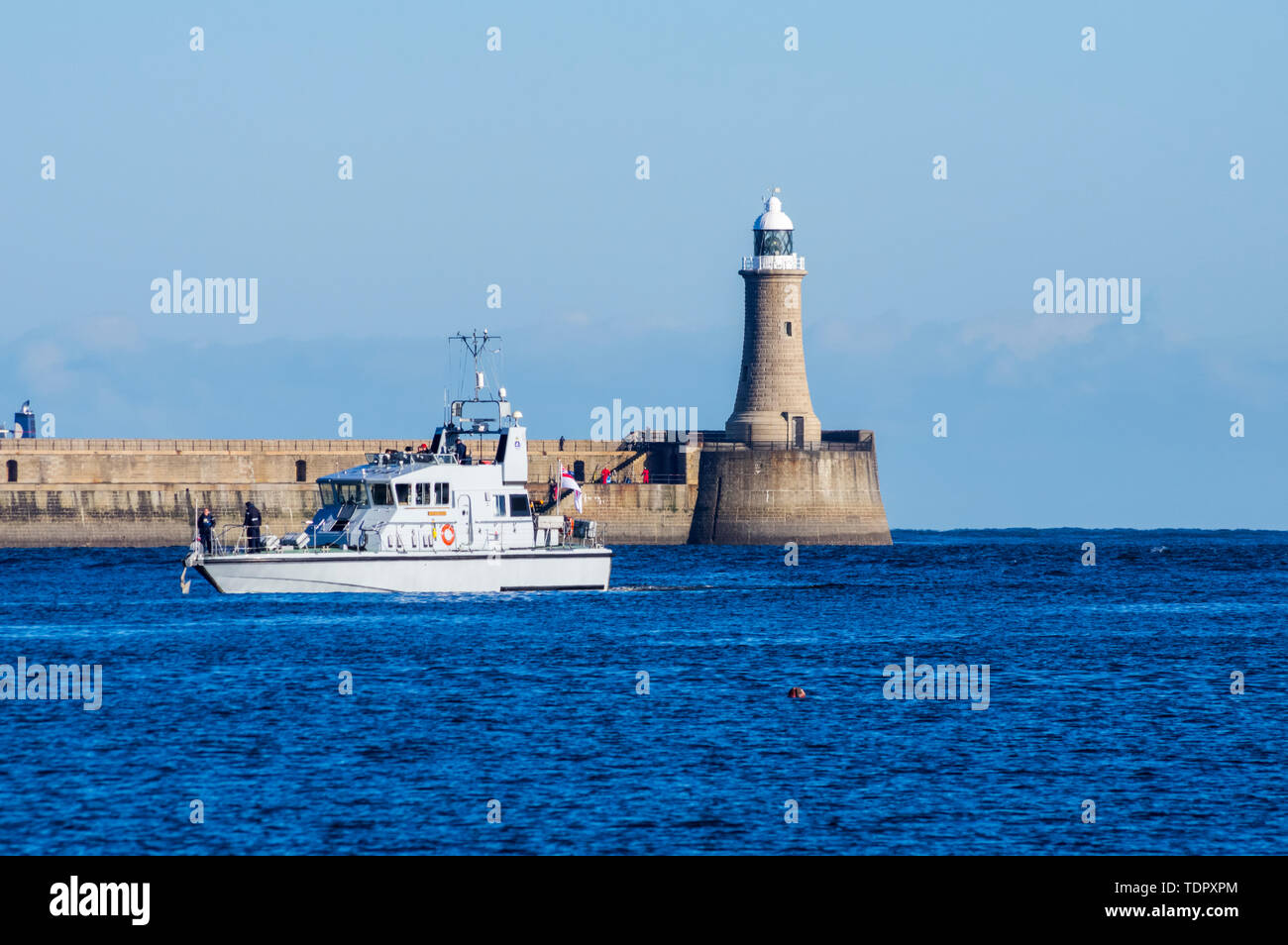 Pier with lighthouse and boat on the River Tyne; South Shields, Tyne ...