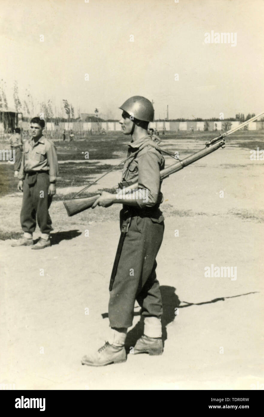 Soldier with the rifle, Italy 1960s Stock Photo - Alamy