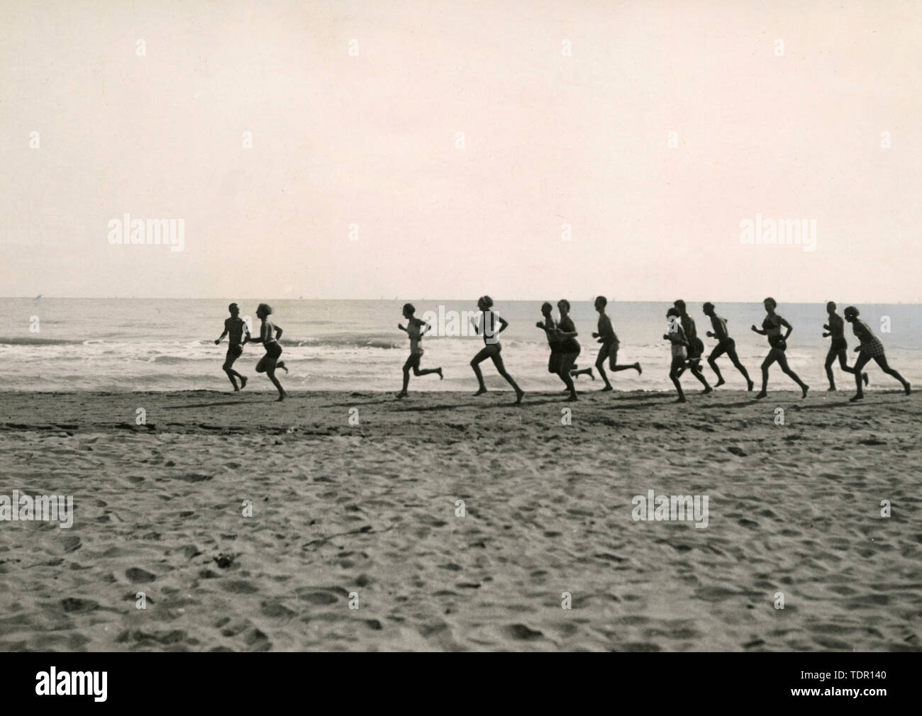 People running on the beach, Italy 1920s Stock Photo - Alamy