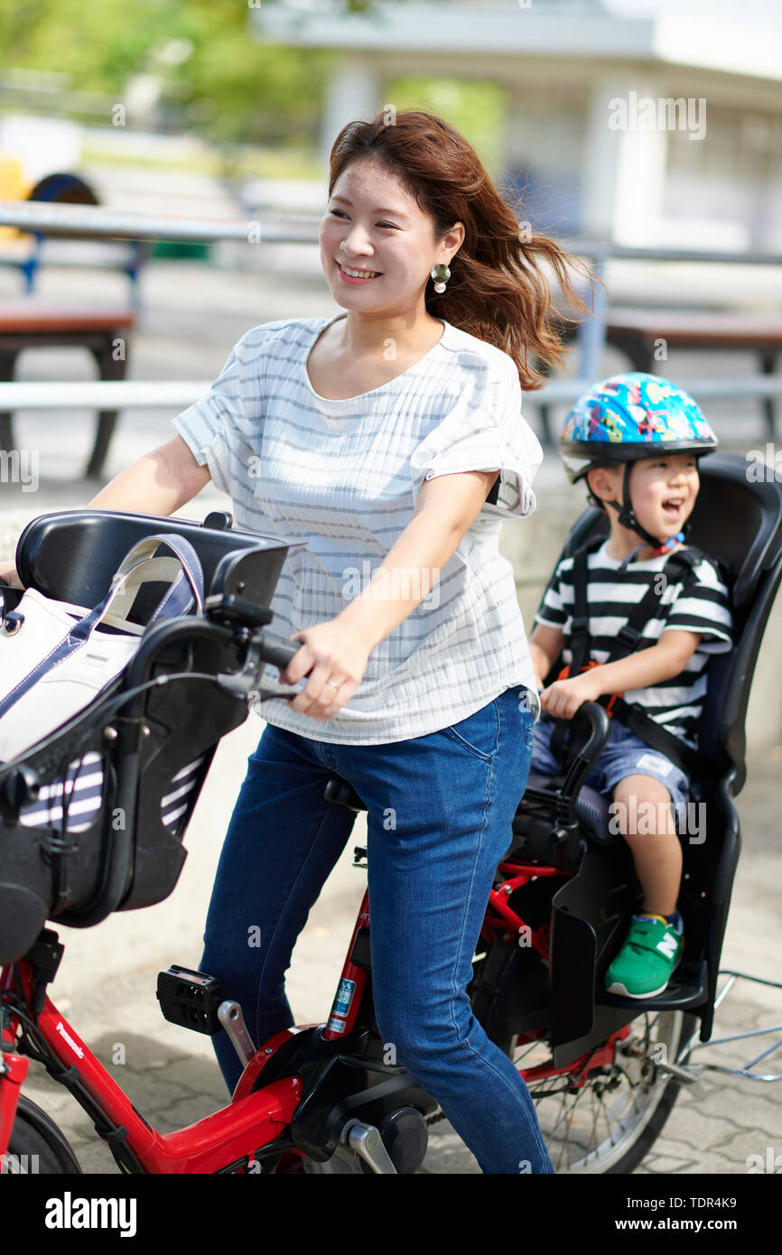 Japanese mother and kid riding a bike Stock Photo - Alamy