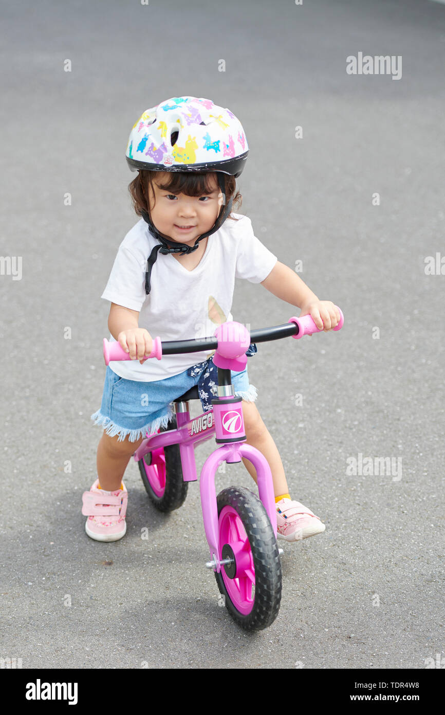 Asian girl on bike hi-res stock photography and images - Alamy