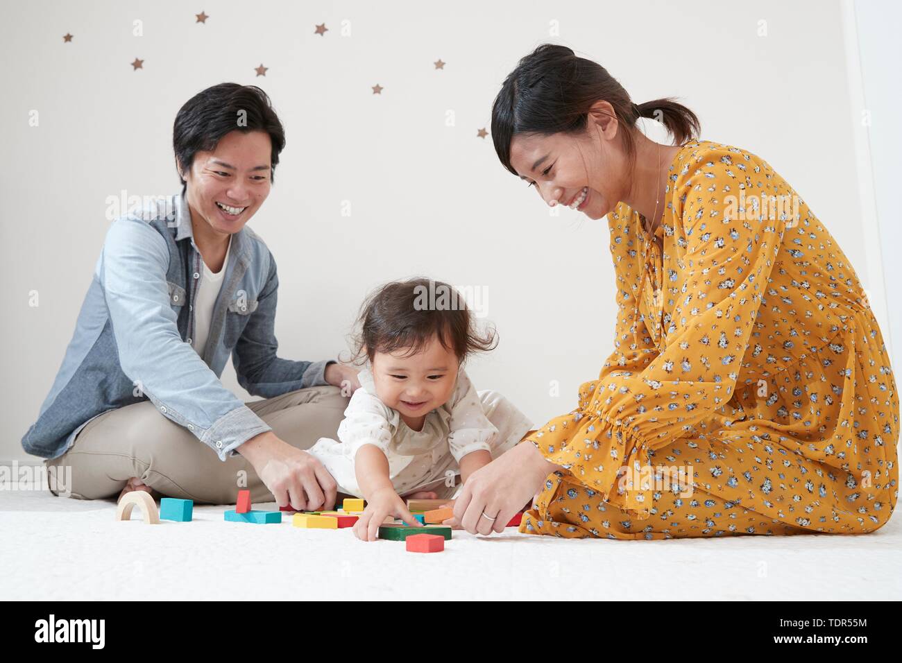 Happy parents watching baby play hi-res stock photography and images ...